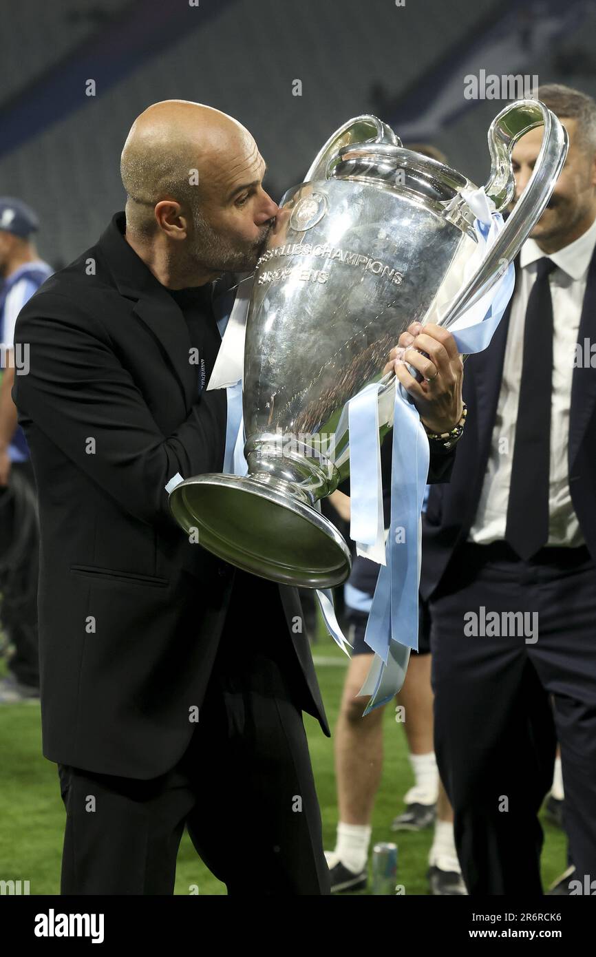 Coach of Manchester City Pep Guardiola celebrates with the trophy ...