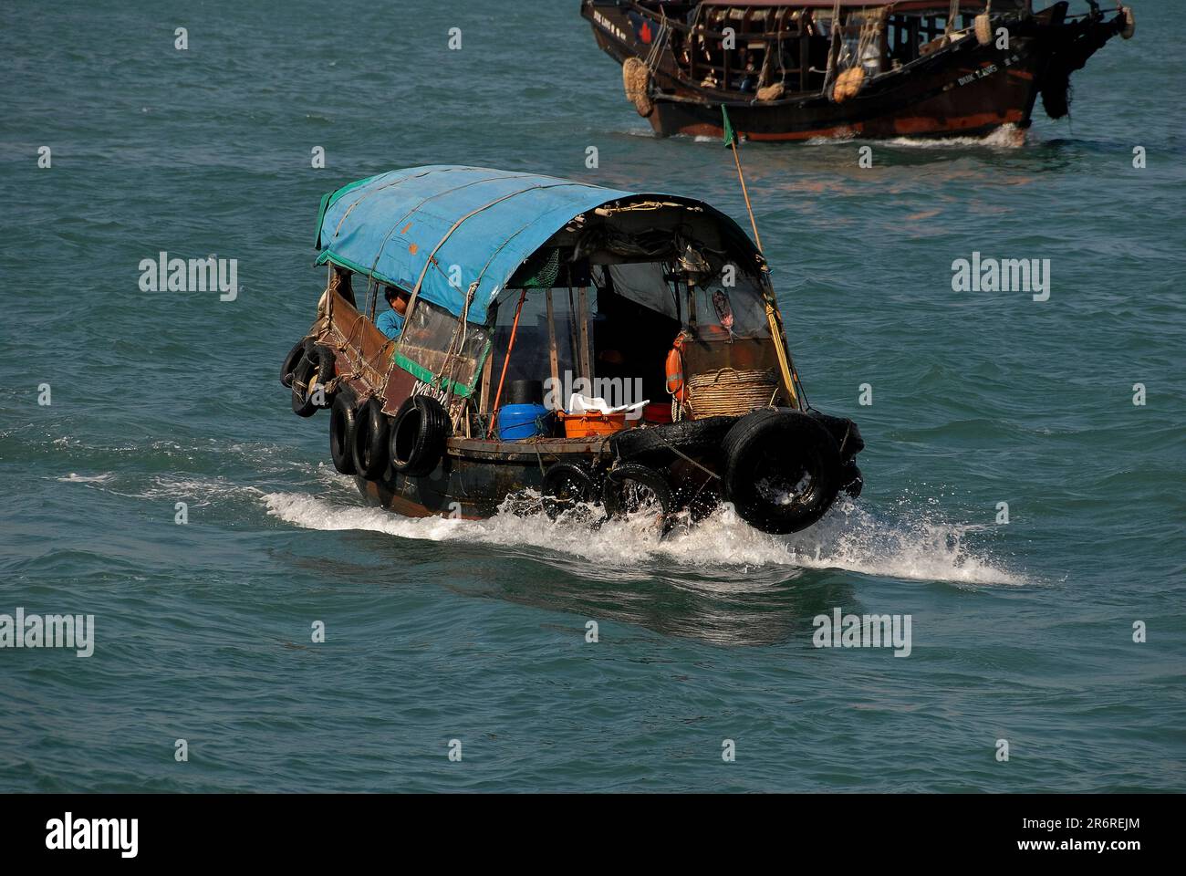 Sampans, traditional small fishing boats, crossing Victoria Harbour ...