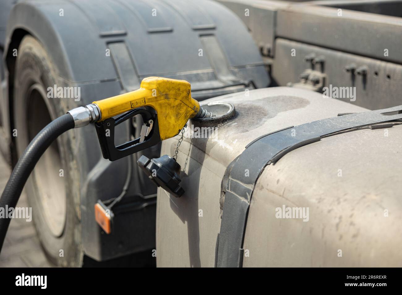 filthy semi-truck on gas station. truck fueling. Hose inserted into the ...