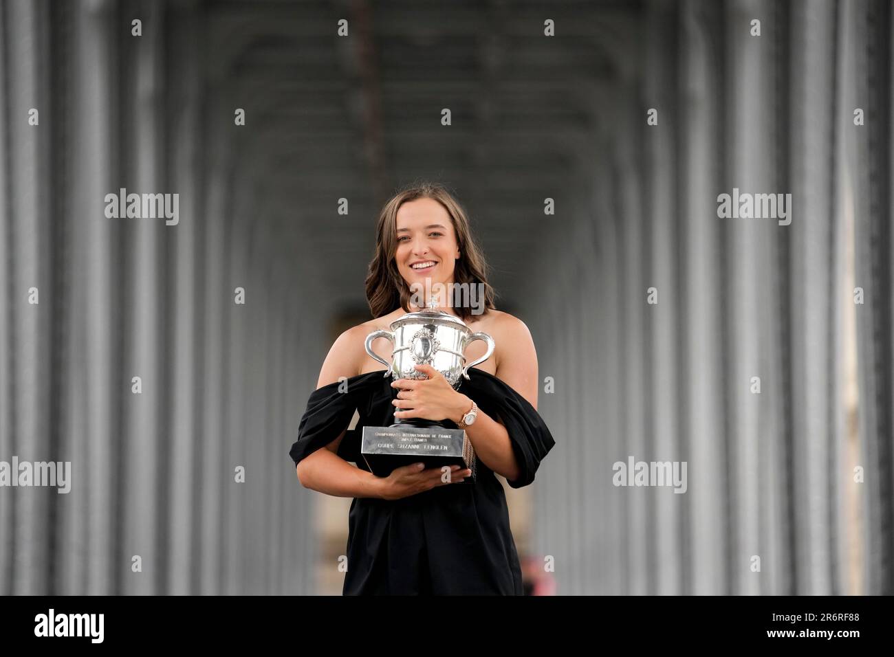 Poland's Iga Swiatek poses with her trophy in Paris, Sunday, June 11 ...