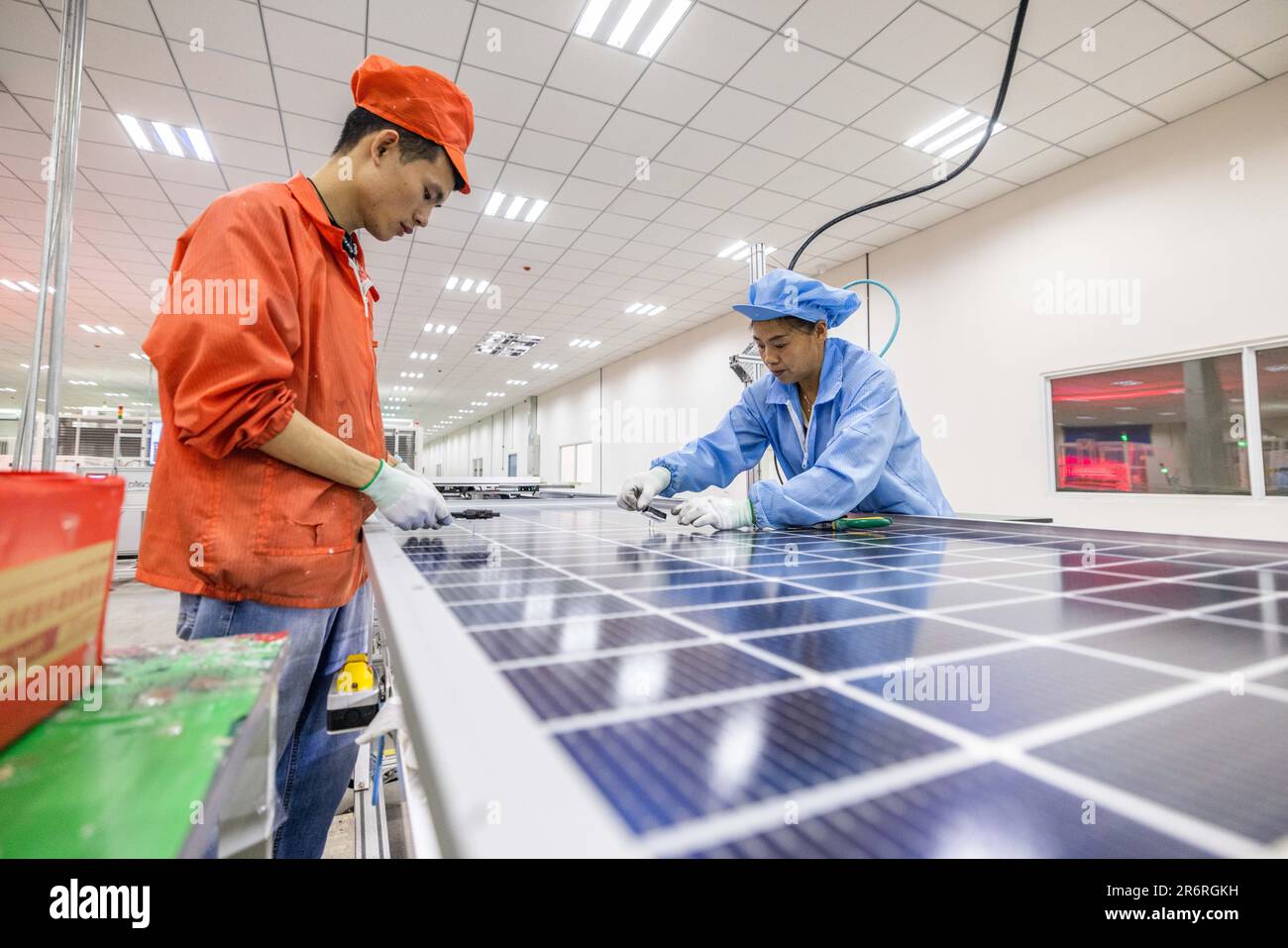 BIJIE, CHINA - JUNE 11, 2023 - Workers work on a photovoltaic panel ...