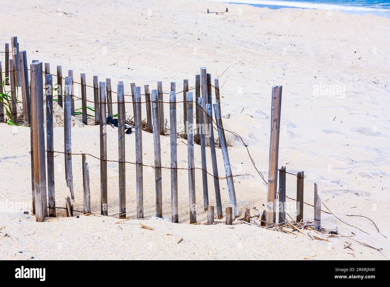 Sand Dune Fence at the beach to save the nature Stock Photo - Alamy