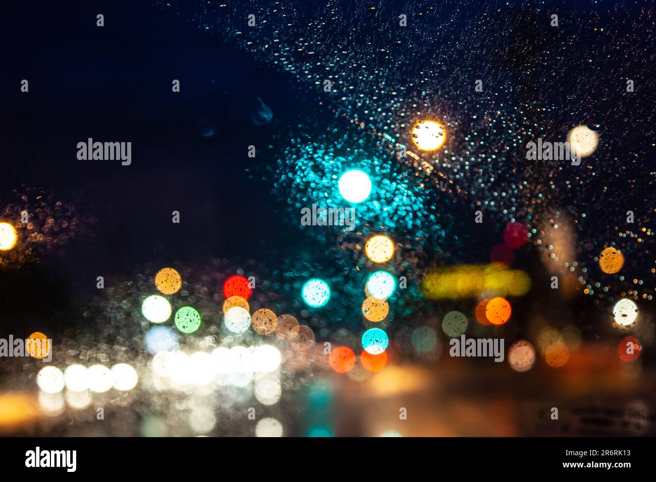 traffic light with red arrow in storm and dark rain clouds defocused as ...