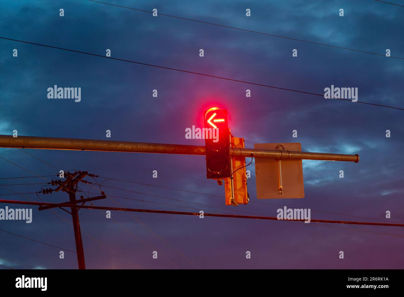 traffic light with red arrow in bad weather with electric pylon and ...