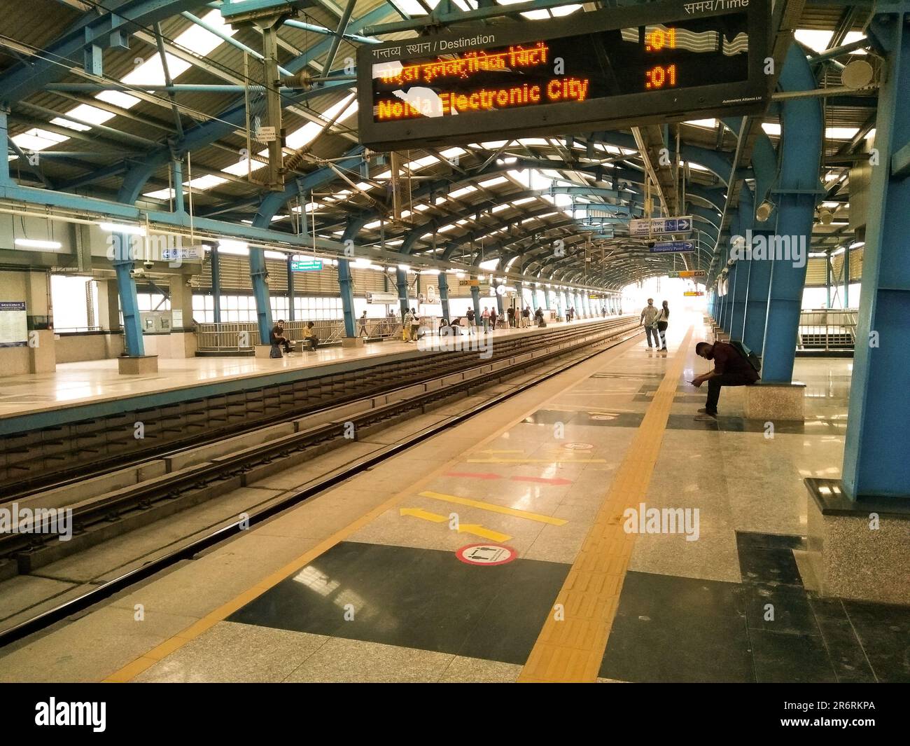 An isolated train station with a deserted platform in the foreground ...