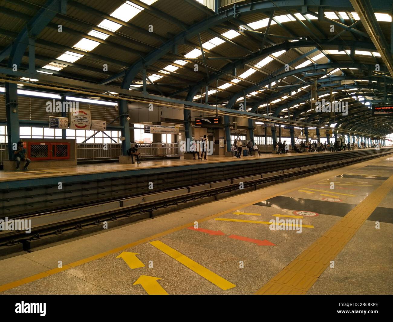 A deserted train station featuring a platform for passenger loading ...