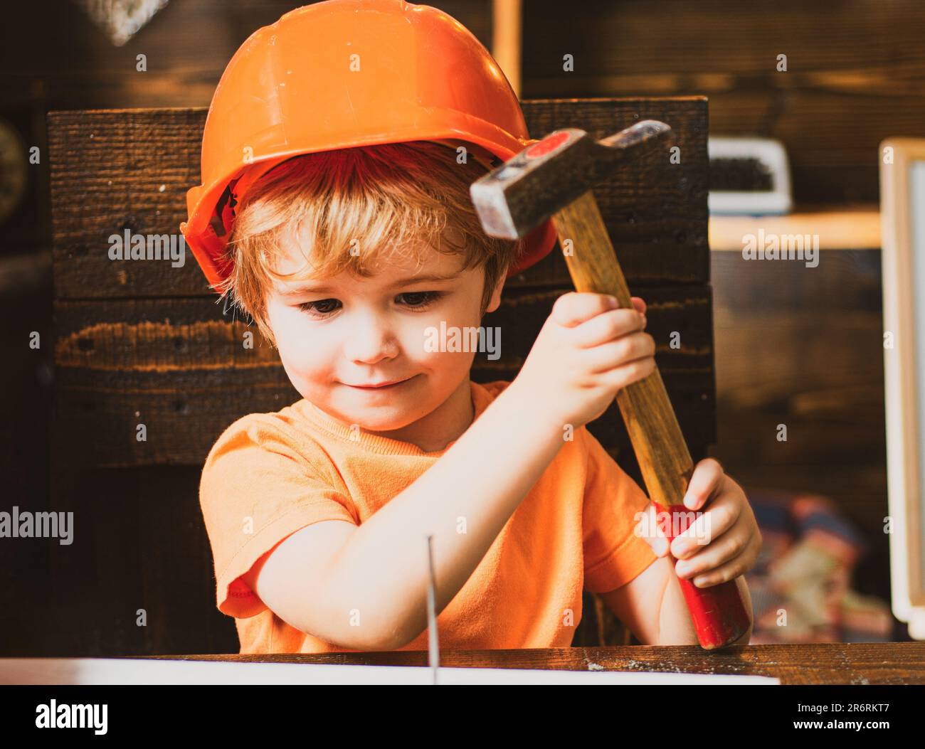 Little boy with a hammer makes repairs. Child is participating actively ...