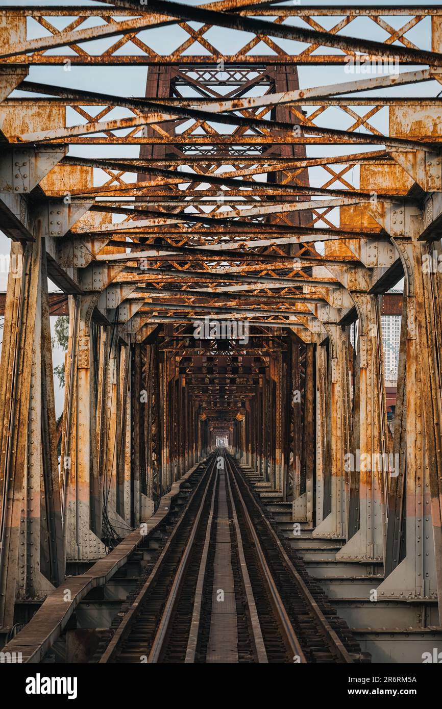 Old rusty iron traditional railway Long Bien bridge structure over the ...