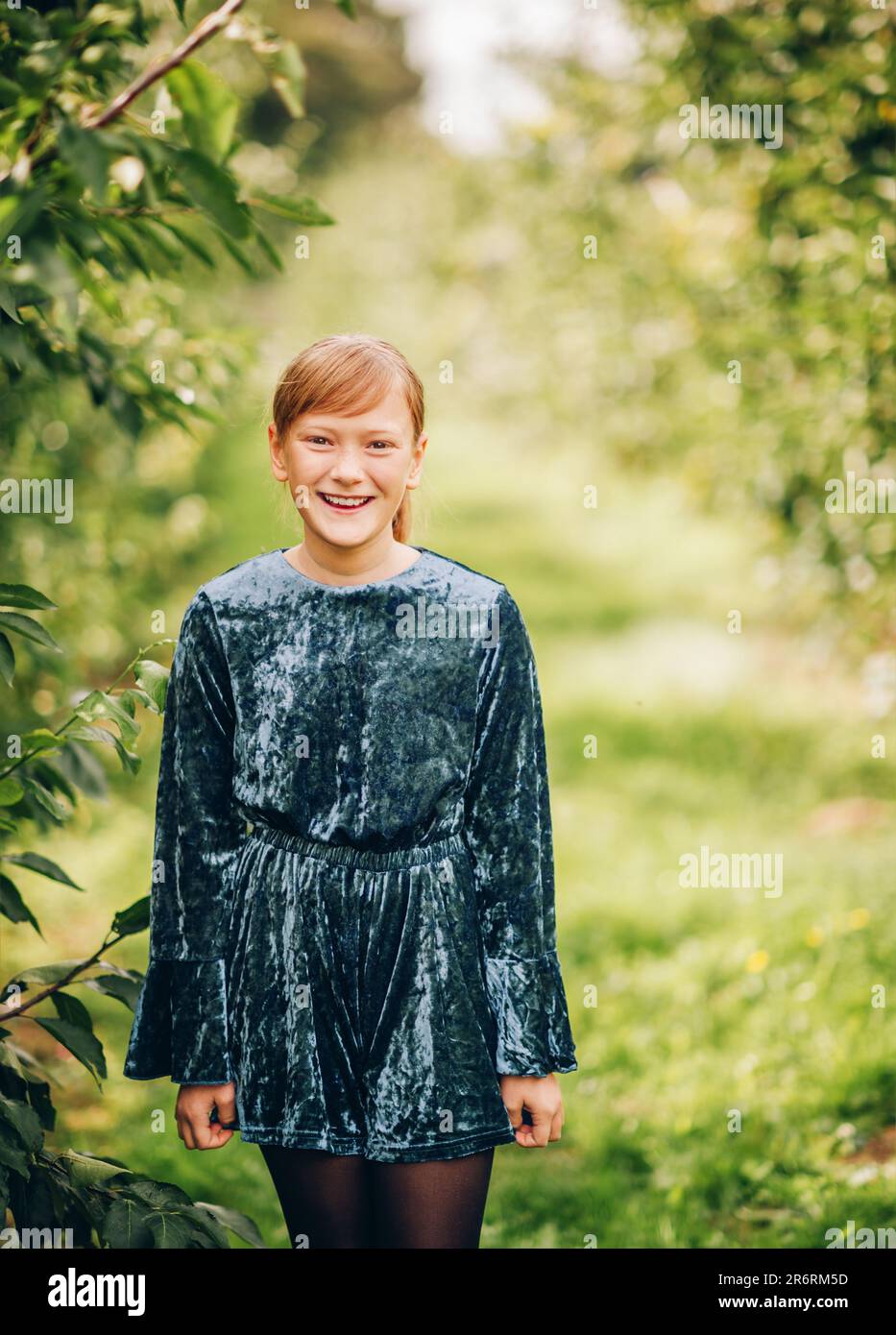 Outdoor portrait of beautiful little 10 year old girl wearing blue ...