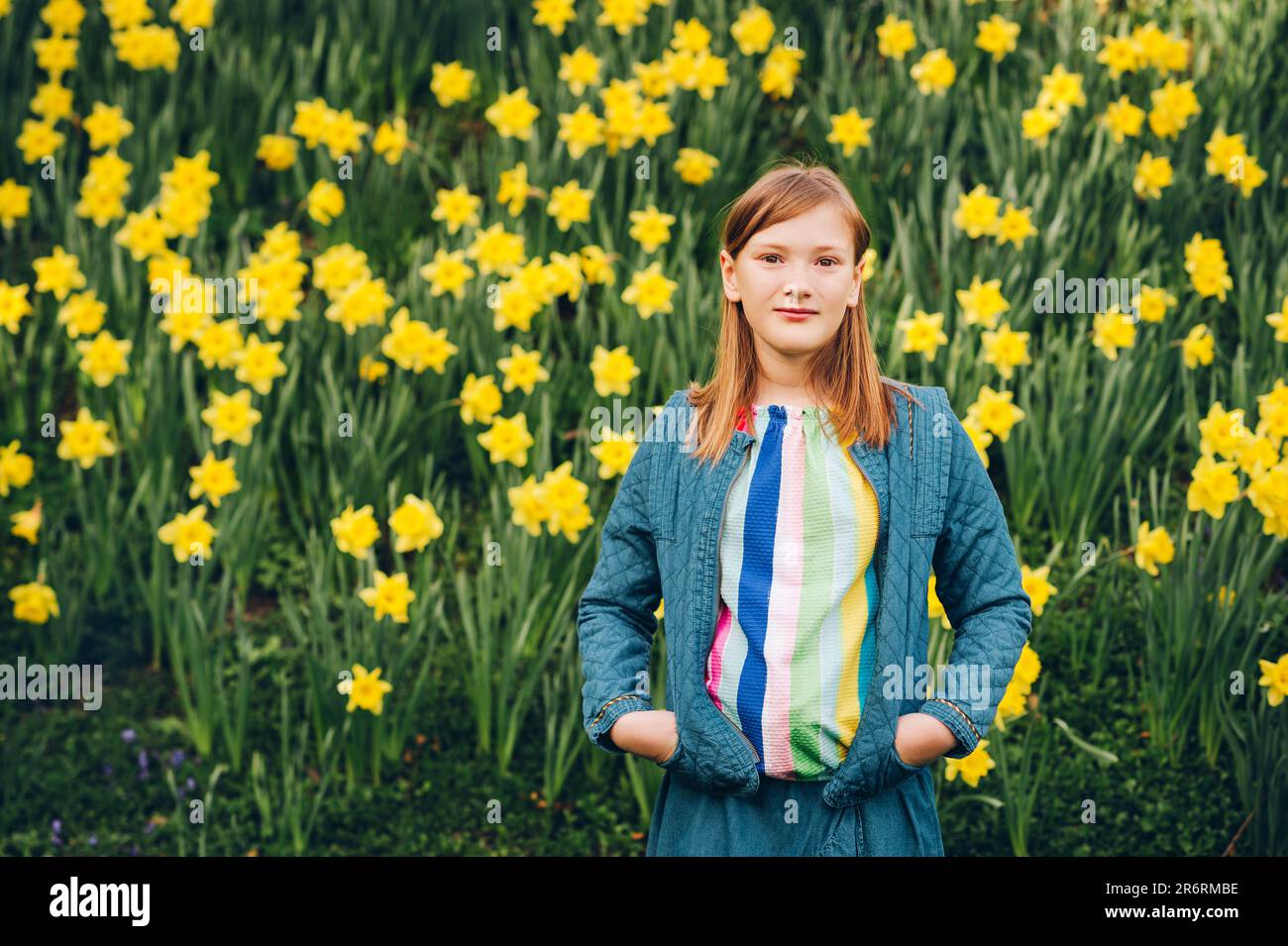 Outdoor spring portrait of young preteen kid girl wearing denim jacket ...