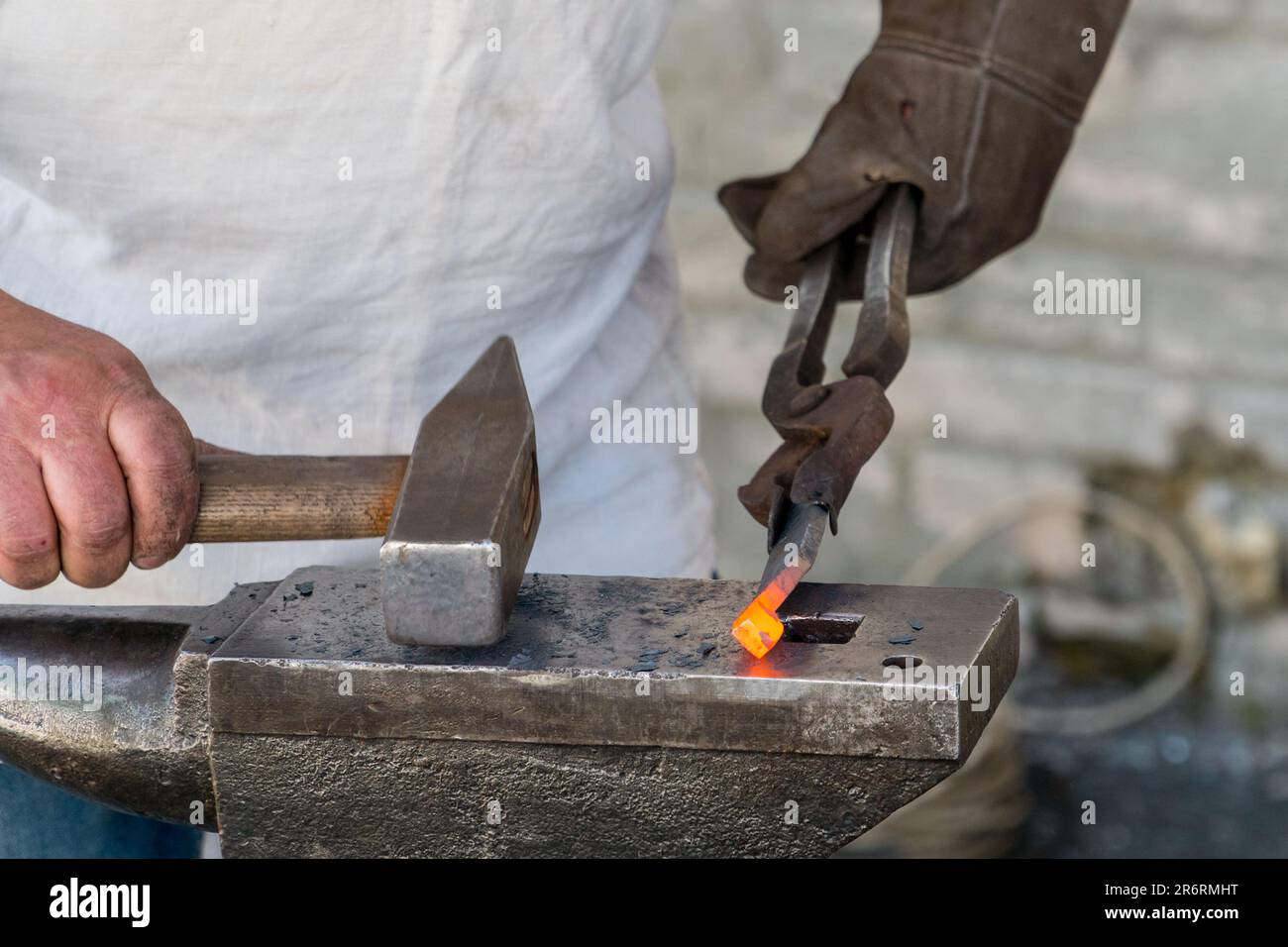 Blacksmith at work making horseshoe in Ukraine. Handmade craftmanship ...
