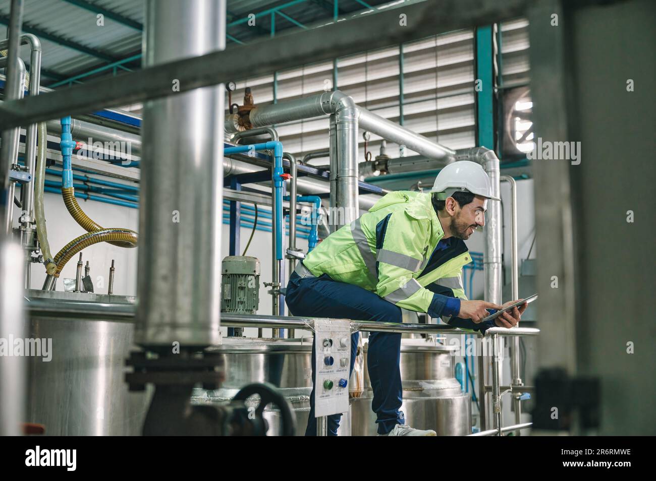 Caucasian technician engineer man in uniform with tablet checking and ...