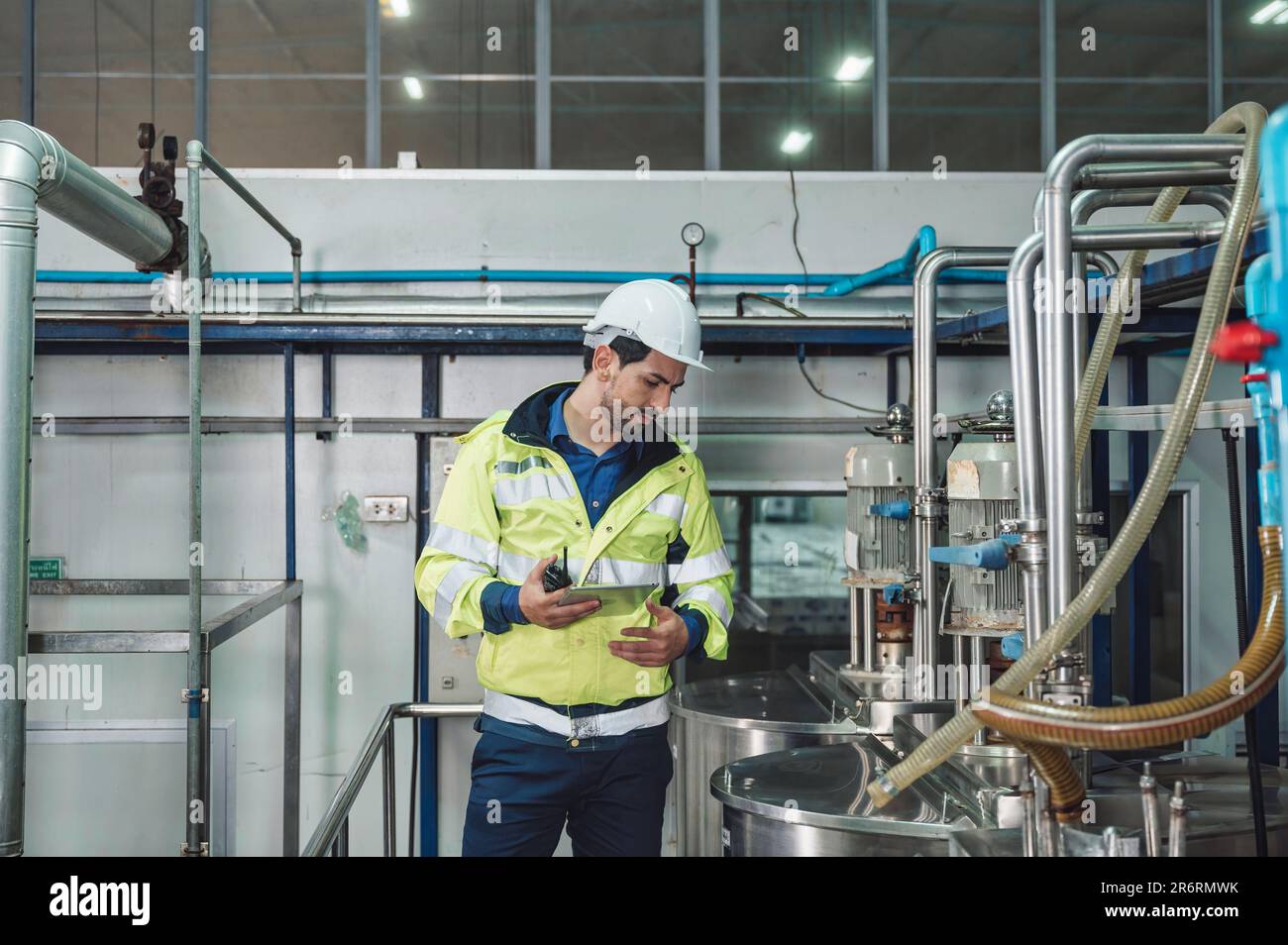 Caucasian technician engineer man in uniform with tablet checking and ...