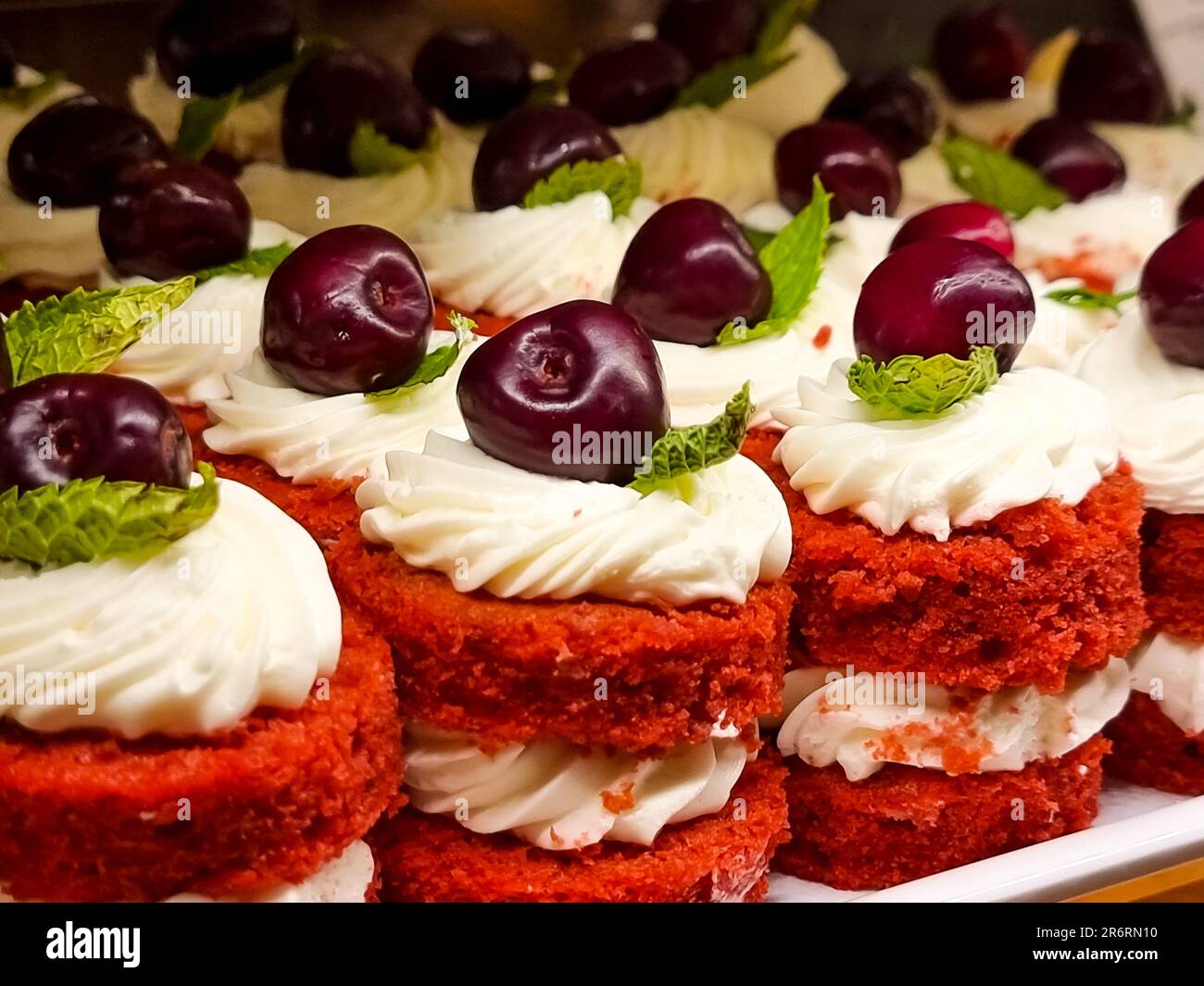 Mini cakes with berries and fruits close up. raspberry, blueberry and ...