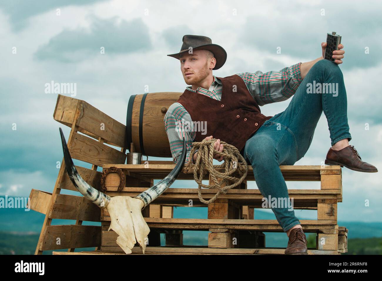 Cowboy farmer man in country side wearing western cowboy hat. Guy ...
