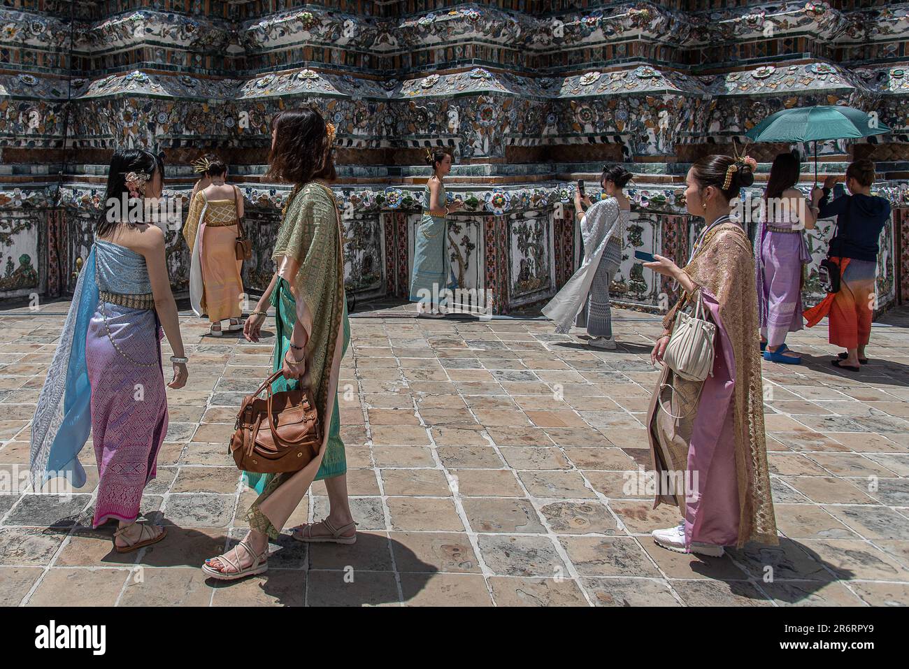 Tourists dressed in traditional Thai clothing seen visiting Wat Arun in ...