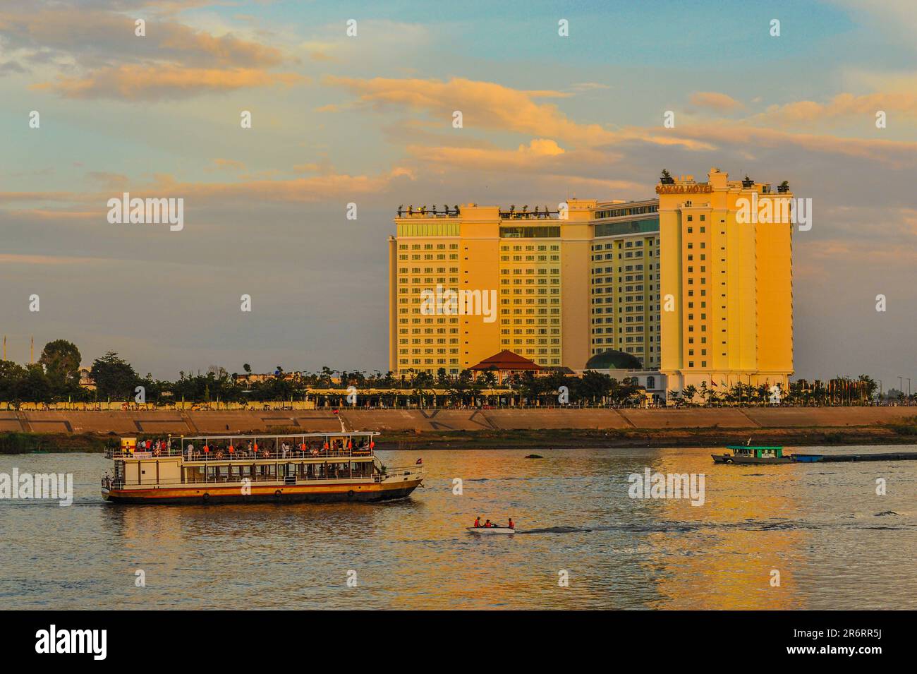 A dinner cruise boat. Riverboat traffic on The Tonle Sap River at dusk ...
