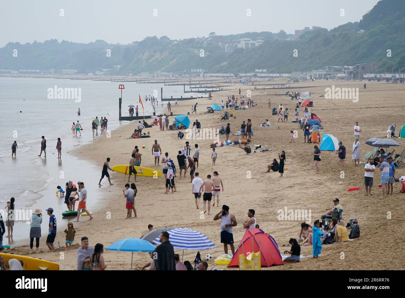 Beachgoers at an overcast Bournemouth beach in Dorset. The Met Office ...
