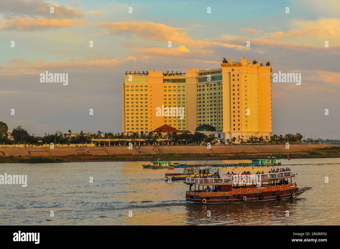 A dinner cruise boat. Riverboat traffic on The Tonle Sap River at dusk ...
