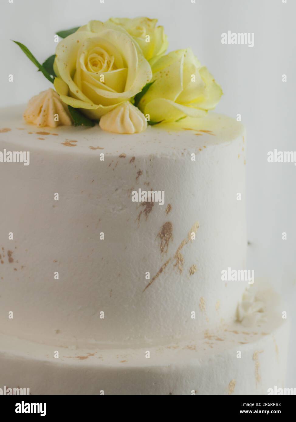 frosted tall cake with real roses and gold brush strokes of edible ...