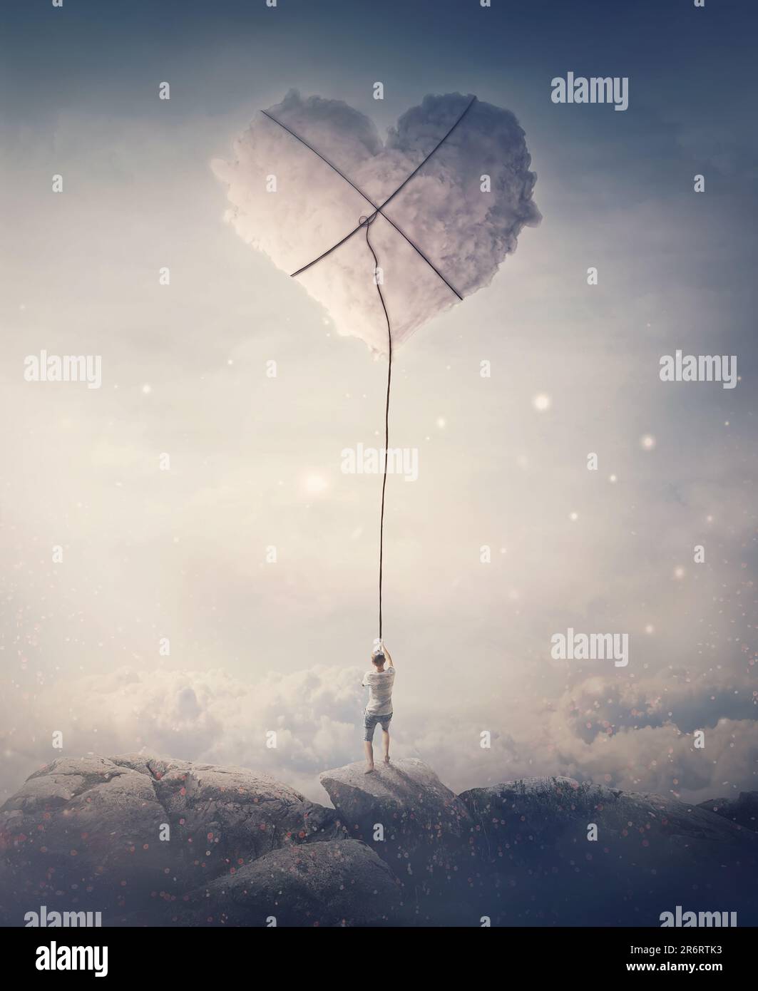 Romantic view of a young man, holding a lasso, trying to catch and pull ...