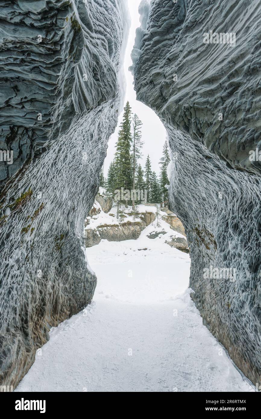 Majestic natural frozen entrance of limestone mountain cave in winter ...