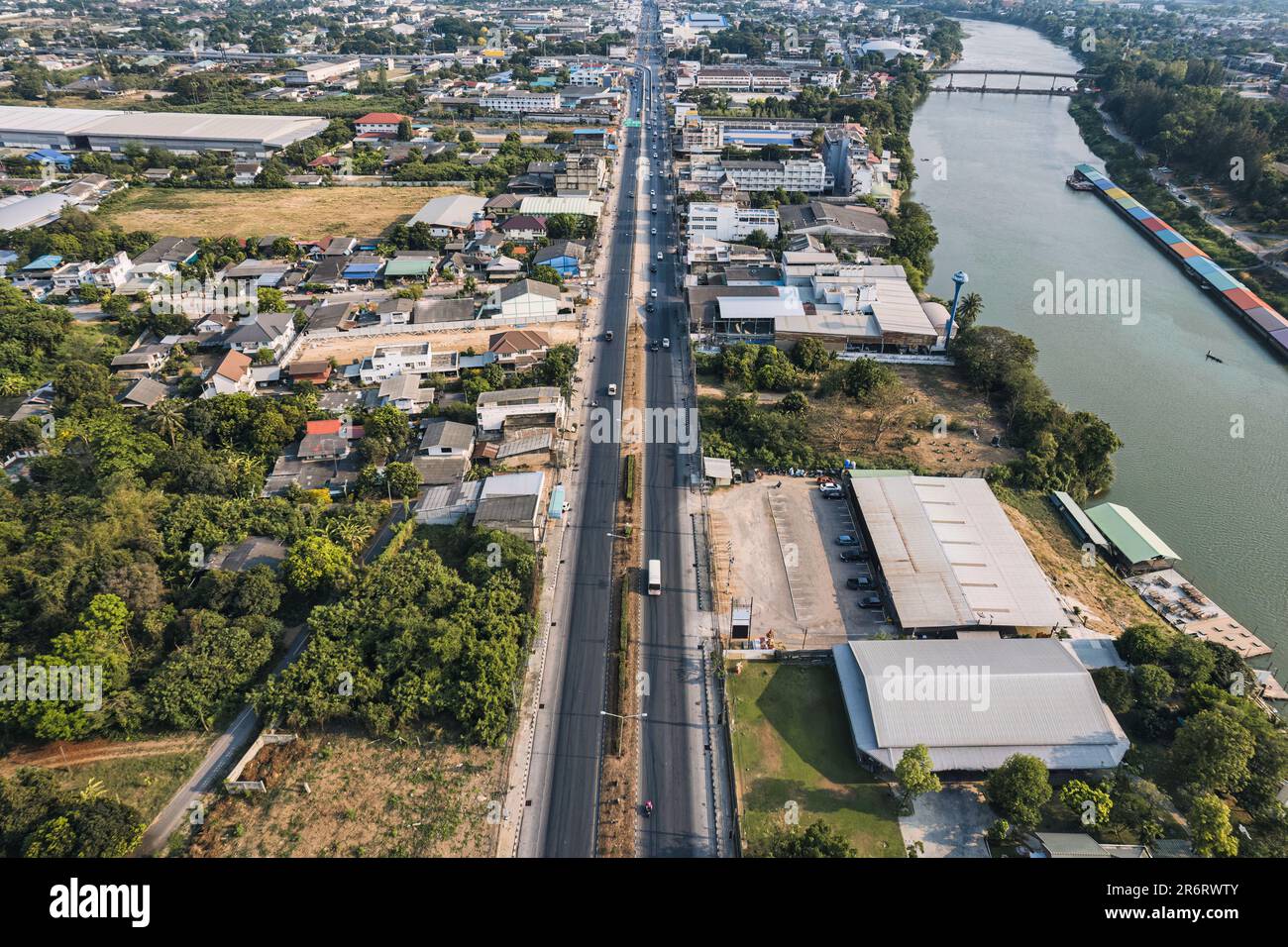 Aerial view of car driving on highway road with local village and ...