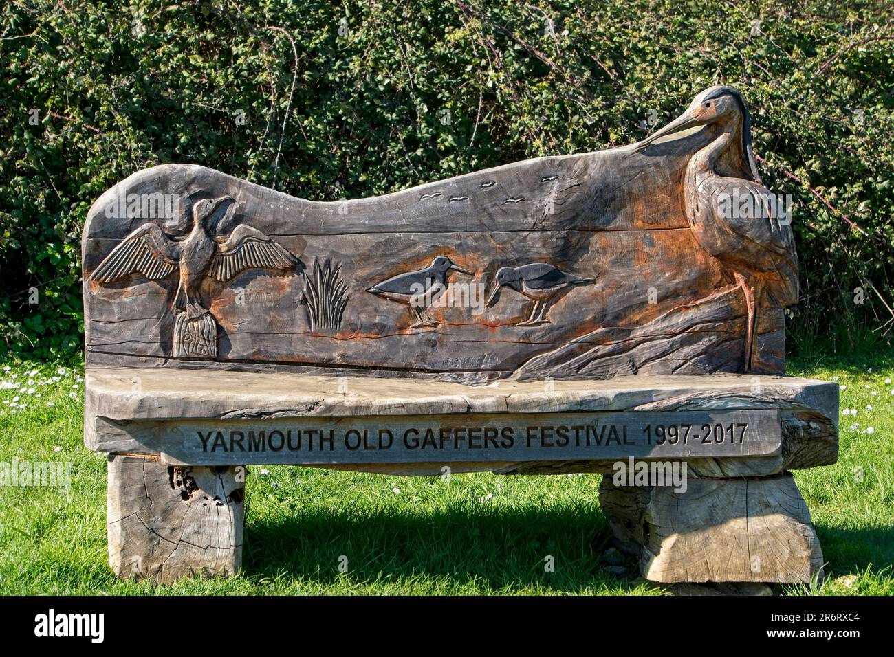 Tree trunk carved into a bench Stock Photo - Alamy