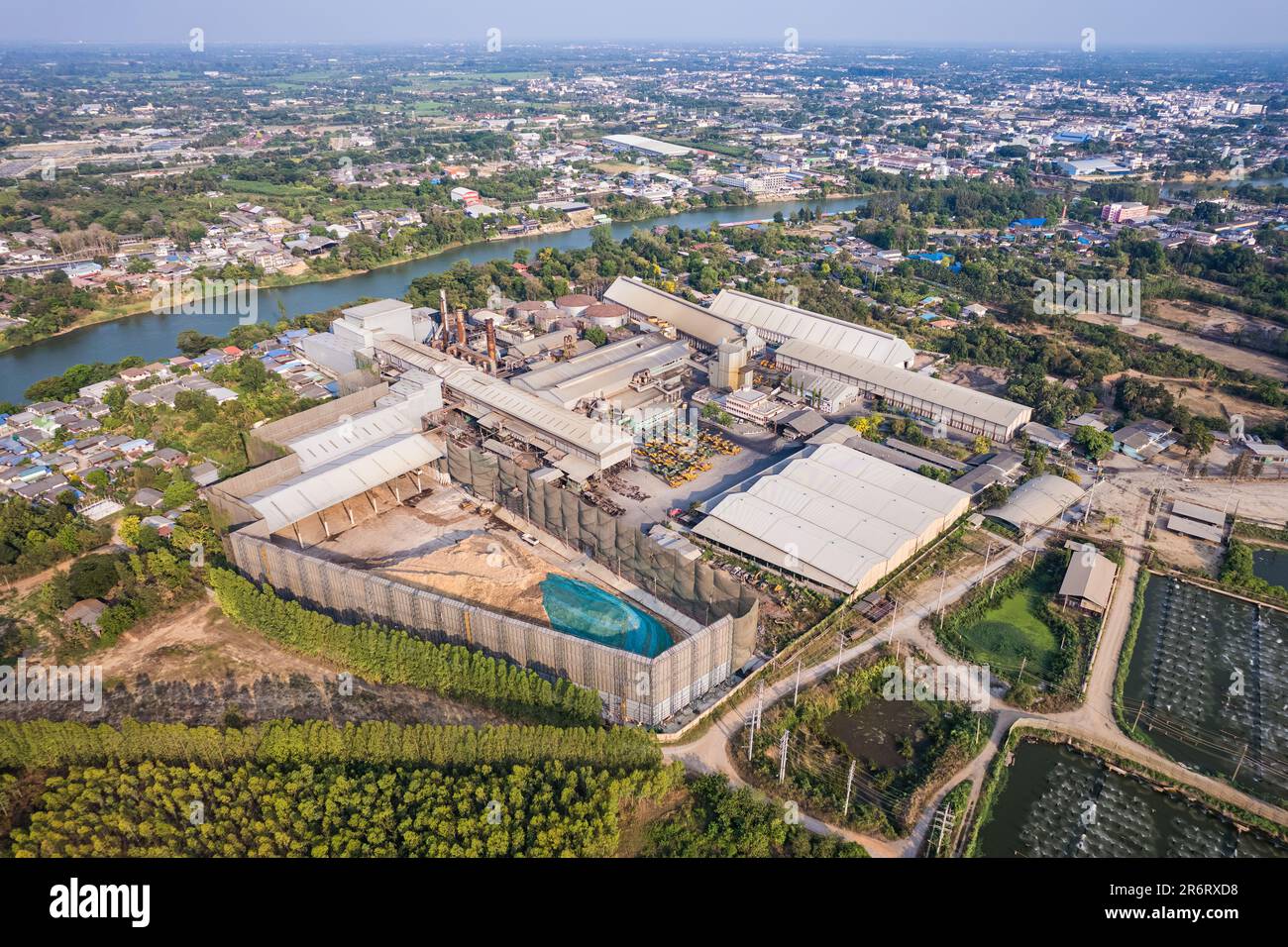 Aerial view of sugar cane biomass processing plant with warehouse, tank ...