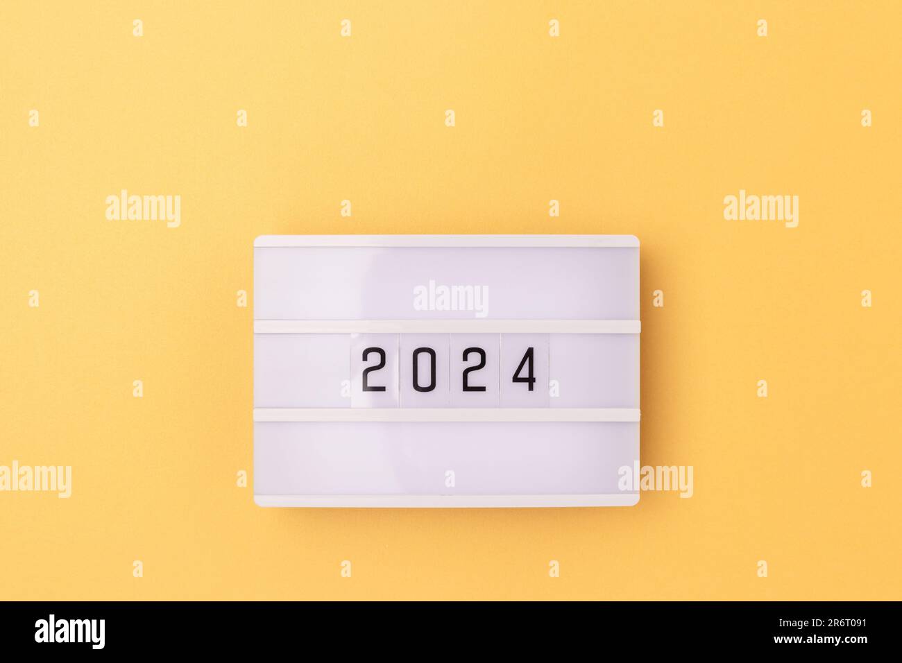 White lightbox with 2024 numbers on a golden background with copy space ...