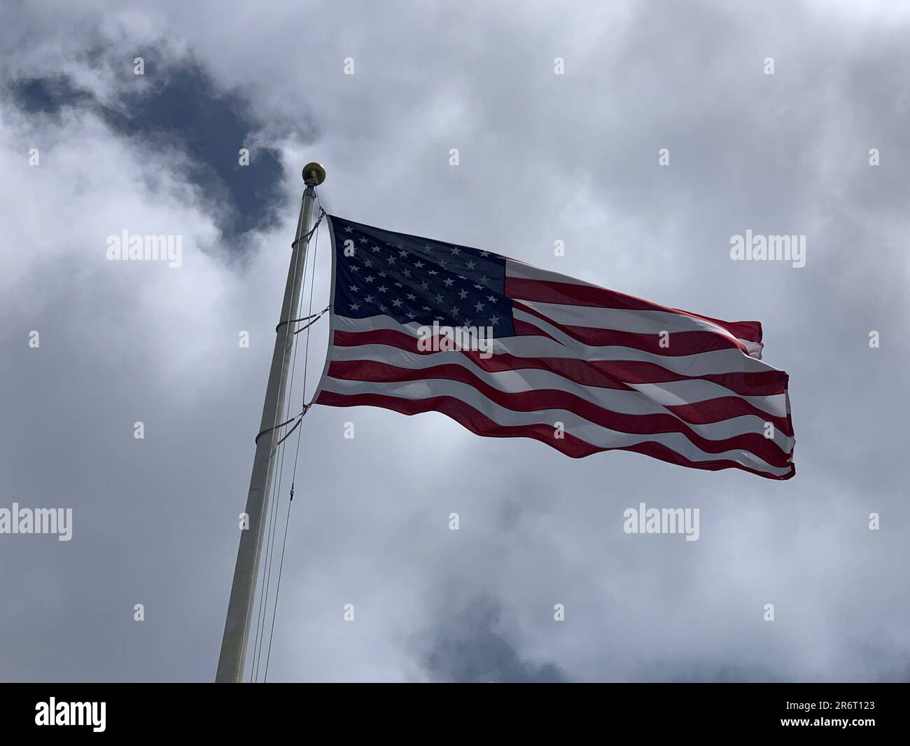 An image of an American flag flying high on a windy day Stock Photo - Alamy