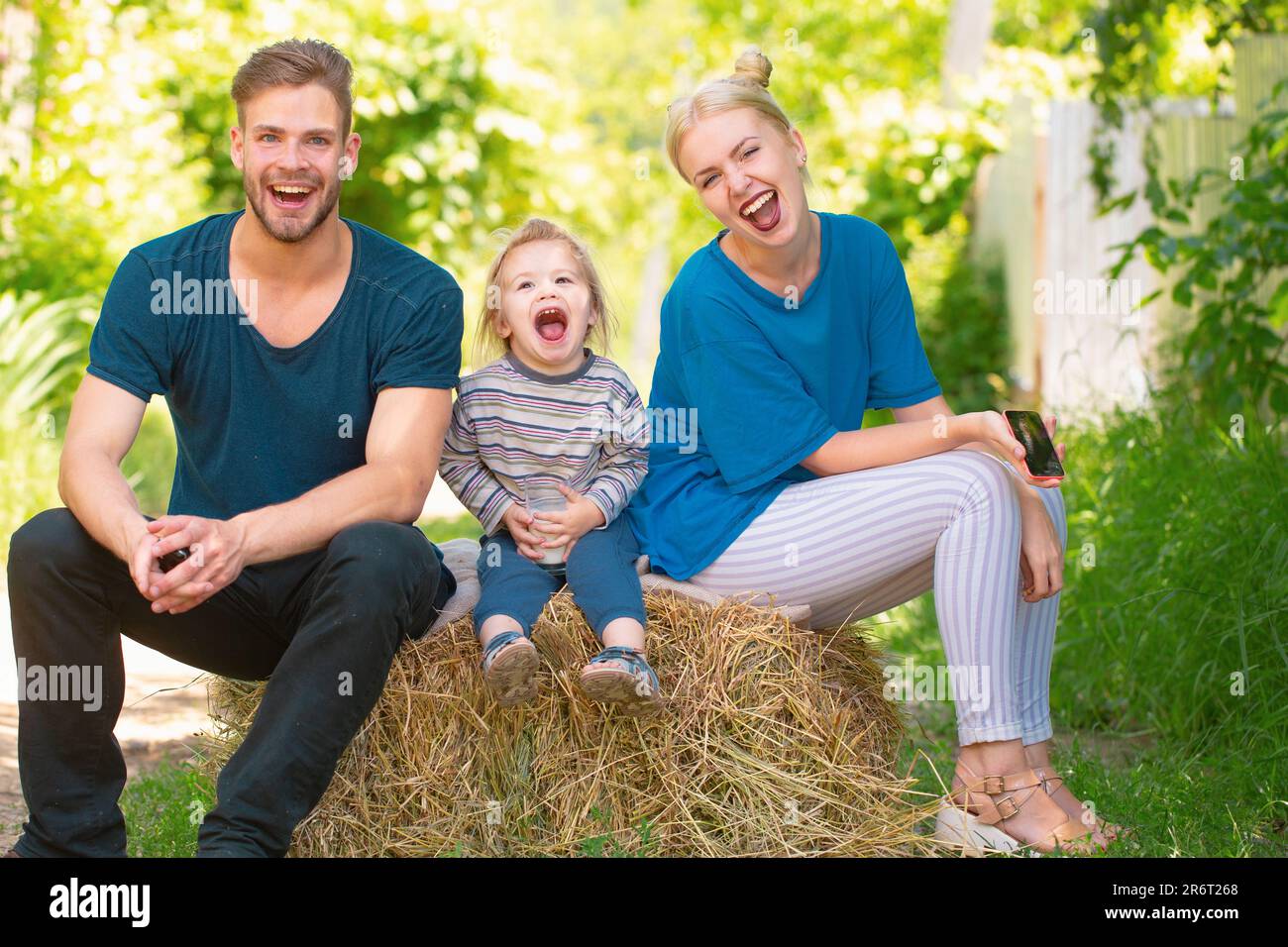 Young family of three having fun together launching. Funny parents ...