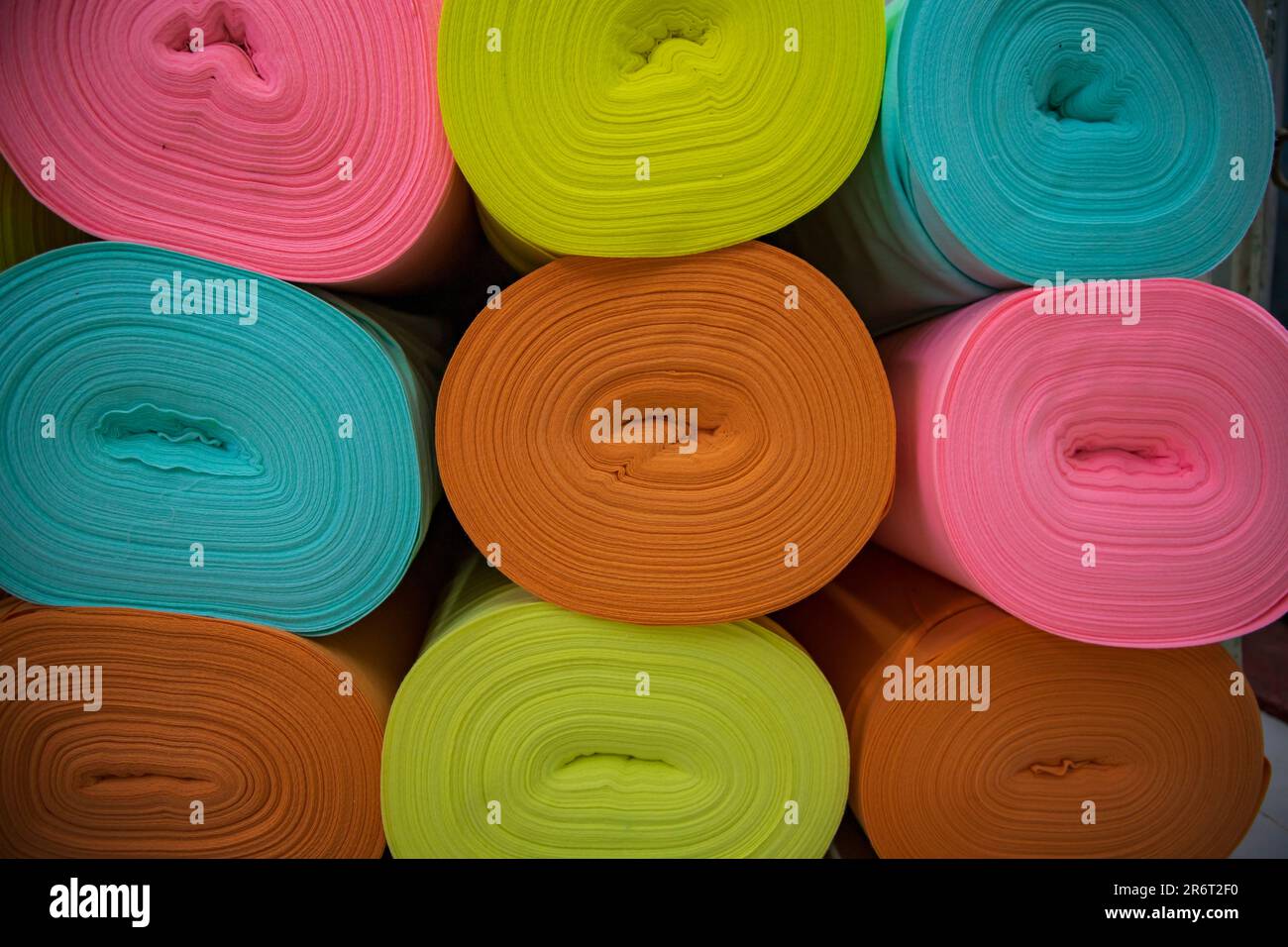 Artistic variety of shade tone colors Textile Fabrics rolls stacked ...