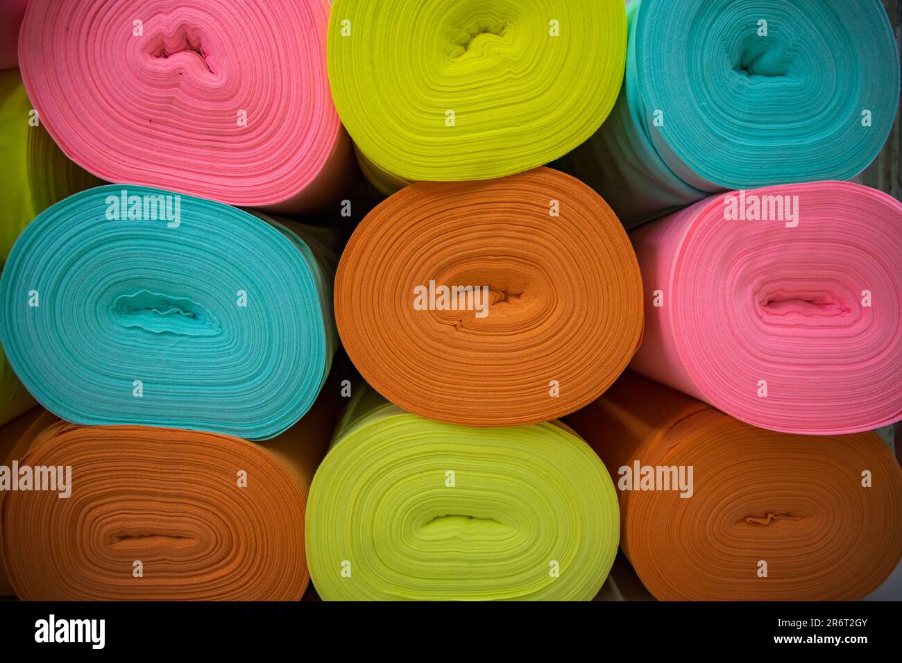 Artistic variety of shade tone colors Textile Fabrics rolls stacked ...