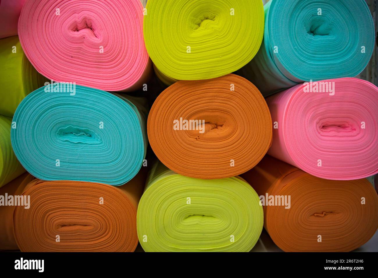 Artistic variety of shade tone colors Textile Fabrics rolls stacked ...