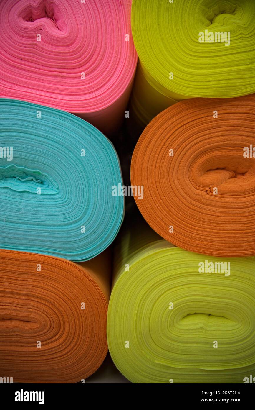Artistic variety of shade tone colors Textile Fabrics rolls stacked ...