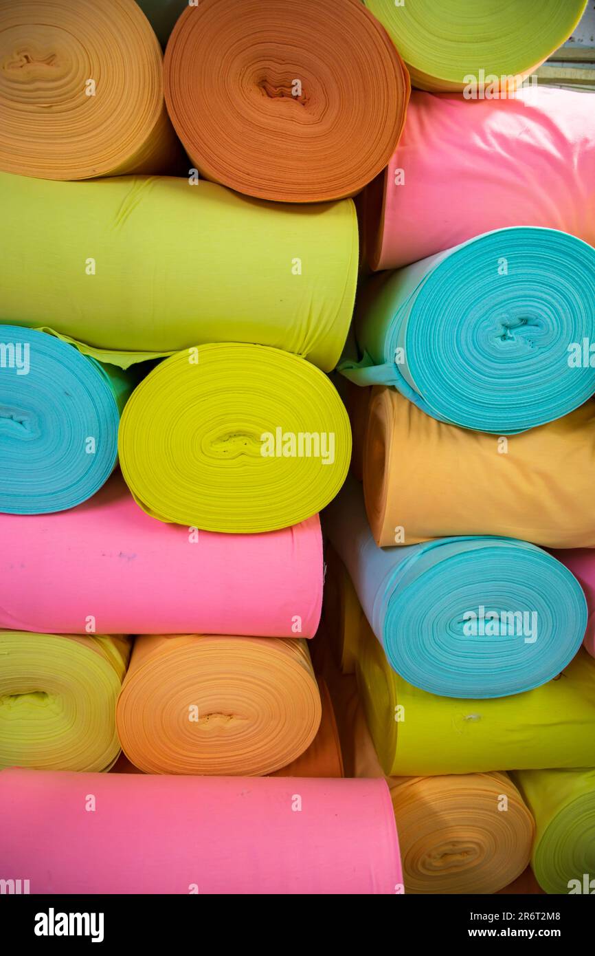 Artistic variety of shade tone colors Textile Fabrics rolls stacked ...