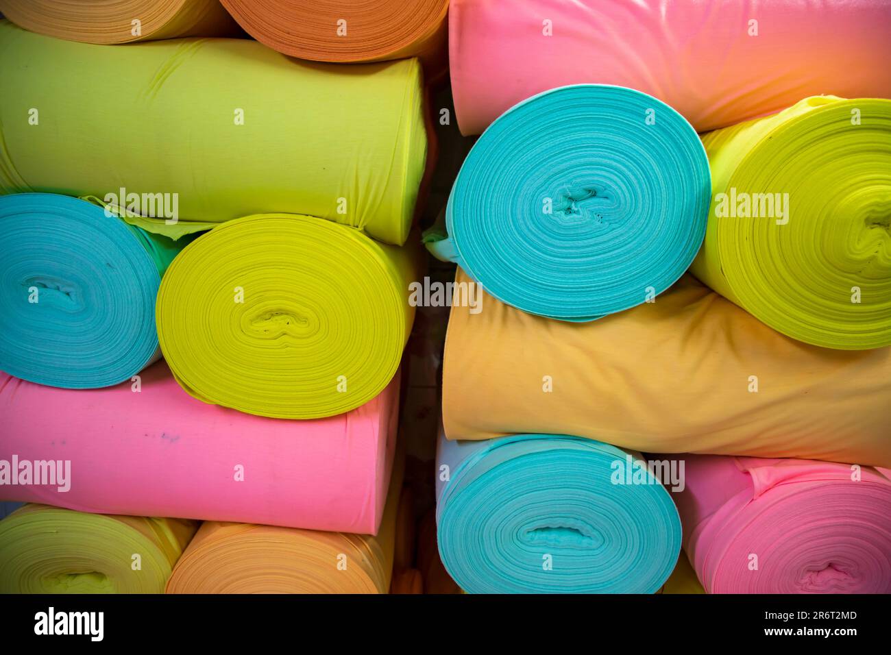 Artistic variety of shade tone colors Textile Fabrics rolls stacked ...