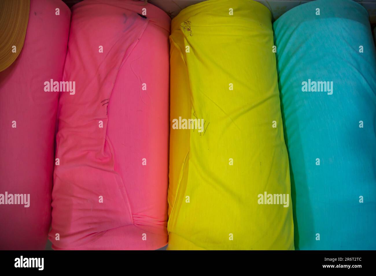 Artistic variety of shade tone colors Textile Fabrics rolls stacked ...