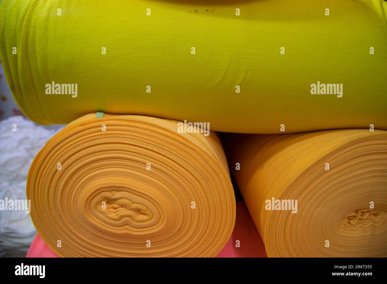 Artistic variety of shade tone colors Textile Fabrics rolls stacked ...
