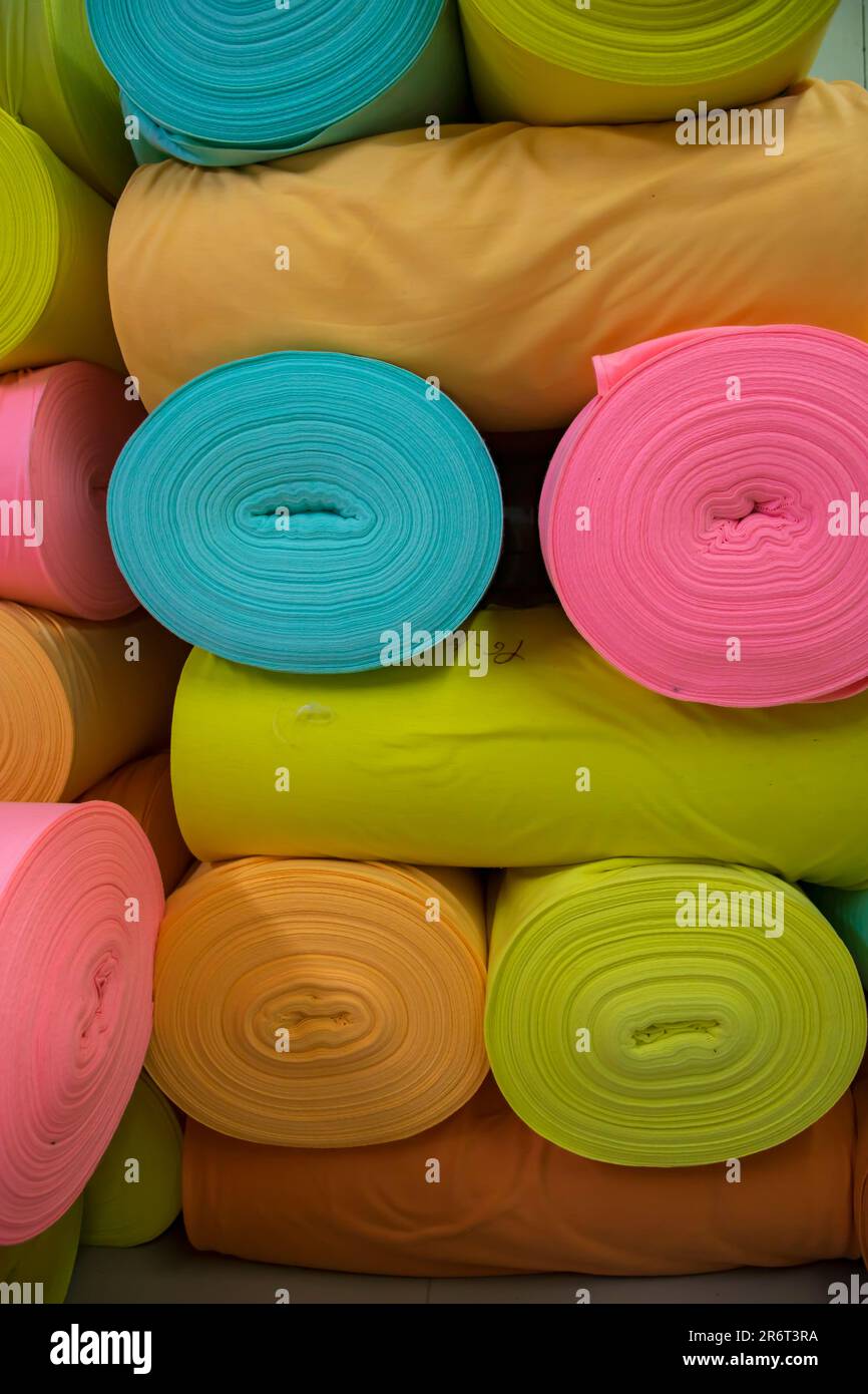 Artistic variety of shade tone colors Textile Fabrics rolls stacked ...