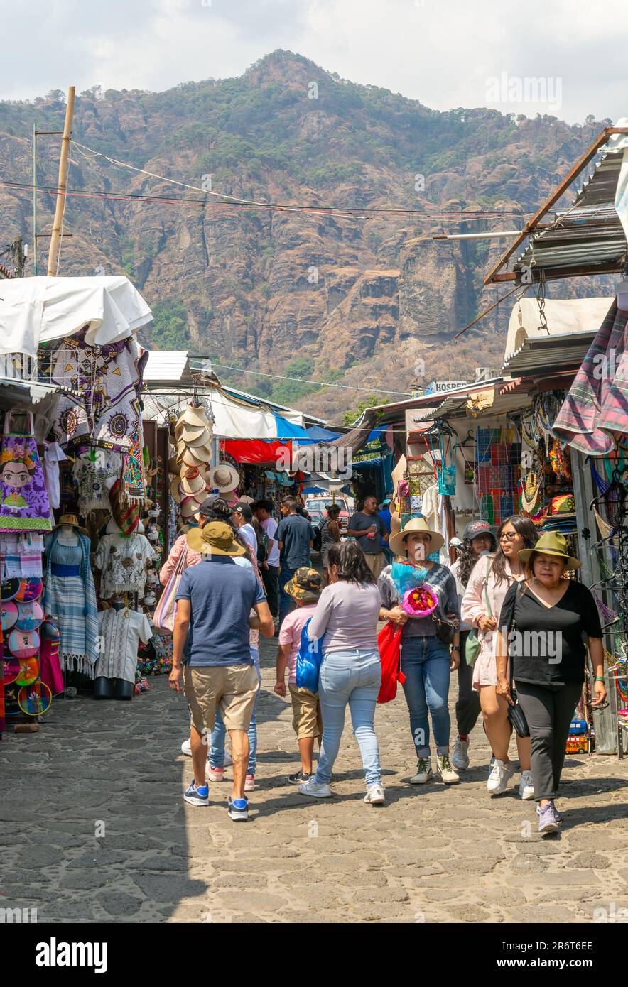 People walking past stalls in the market, Tepoztlán, State of Morelos ...