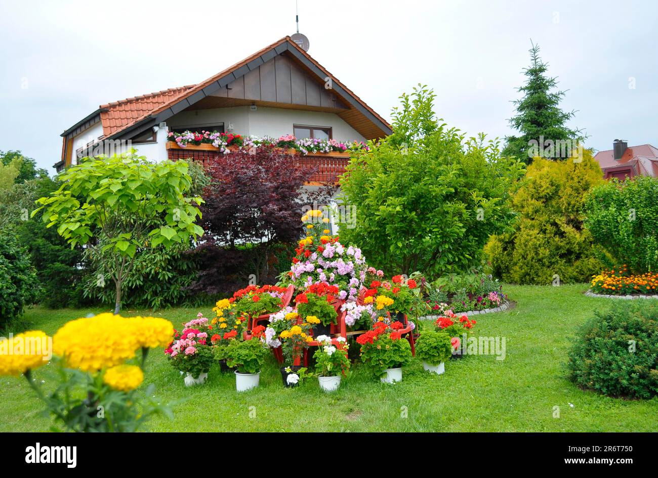 Flower pyramid in the garden, flower pot with flowers, lawn Stock Photo ...