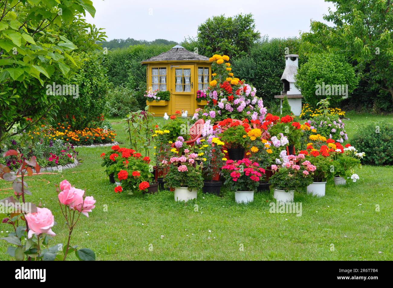 Pyramid of flowers in the garden, gazebo in the garden Stock Photo - Alamy