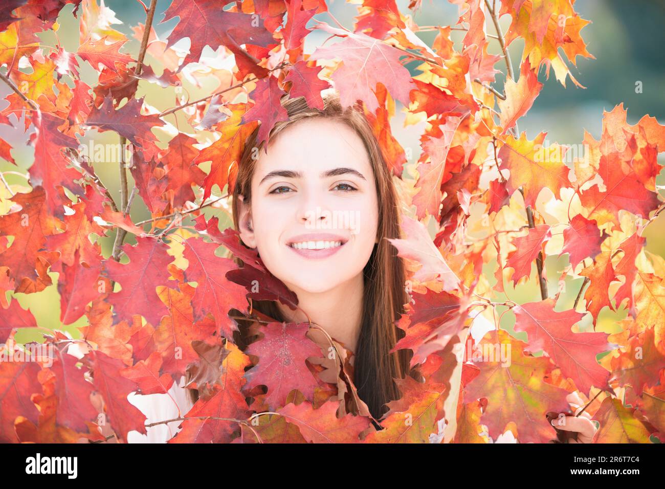 Beautiful happy girl enjoying autumn. Young smiling woman and autumn ...