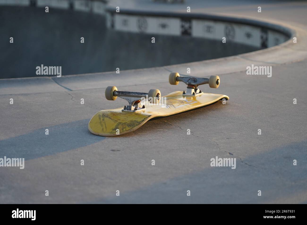 A Yellow skateboard lying upside down on a skate track Stock Photo - Alamy