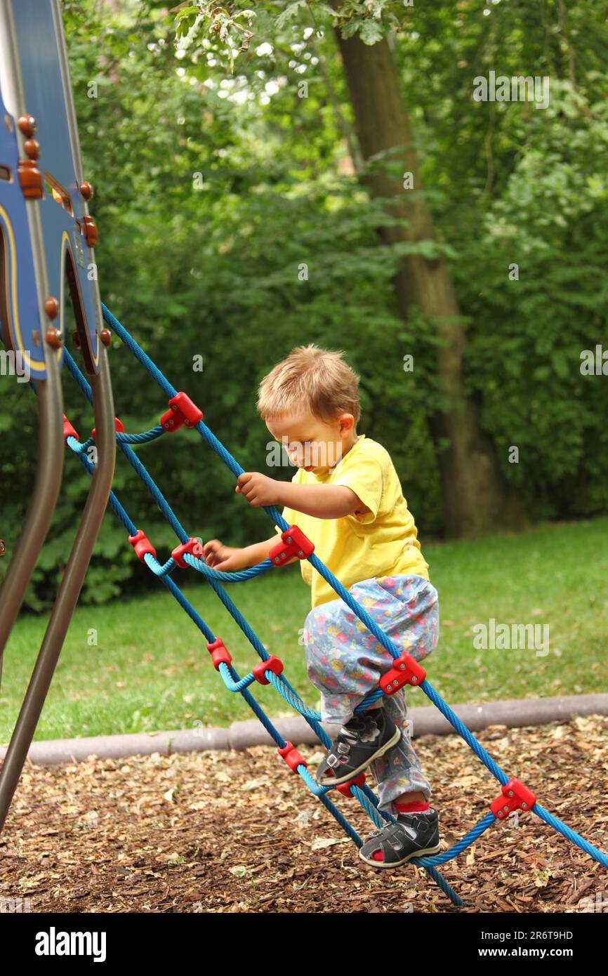 Photo of kid playing at playground Stock Photo - Alamy