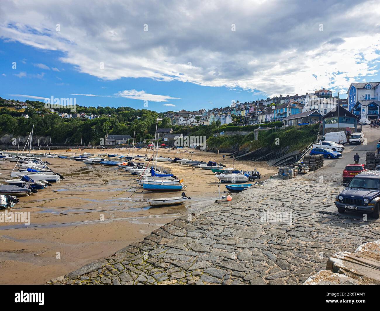 boats ashore along the sandy beach at New Quay, Ceredigion, West Wales ...