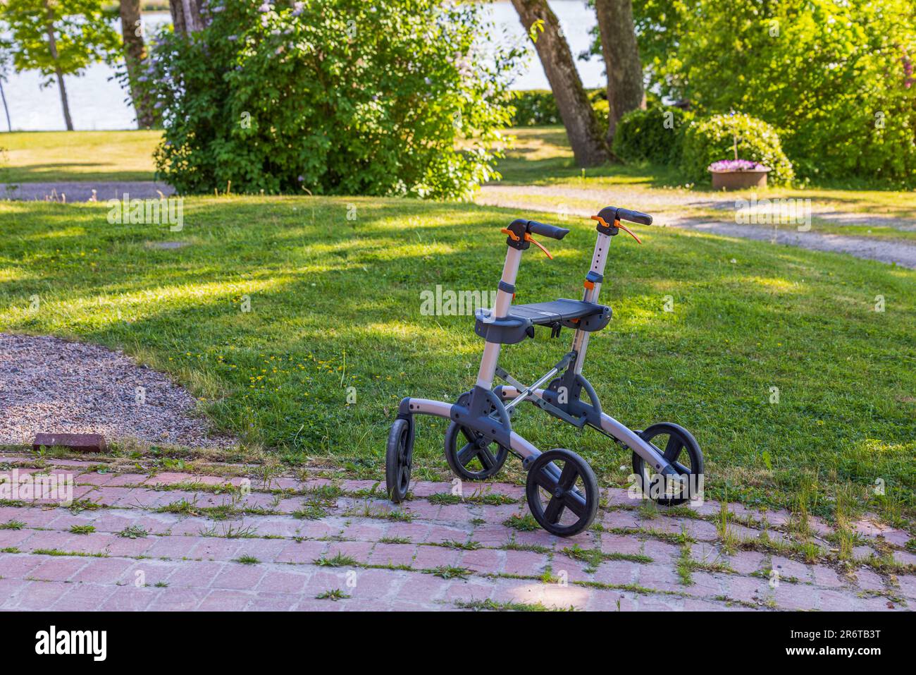 Close-up view of rolling walker left outside on green nature landscape ...