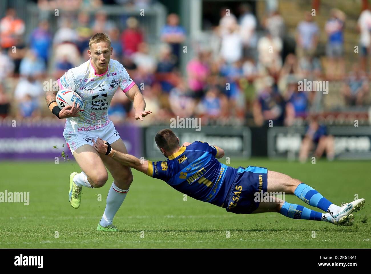 Leeds’ Mikolaj Oledzki evades a tackle from Wakefield Trinity’s Max ...
